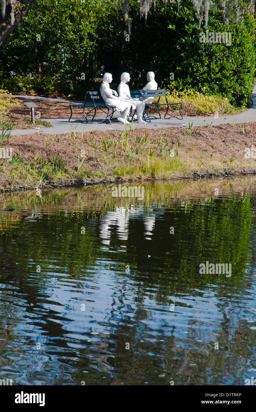 Three white sculptures figures sitting on the park's bench, Sculpture ...