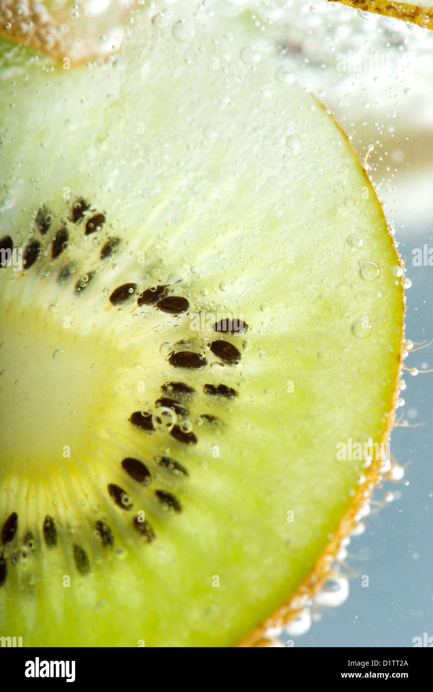 Tasty kiwi in mineral water with bubbles macro Stock Photo - Alamy