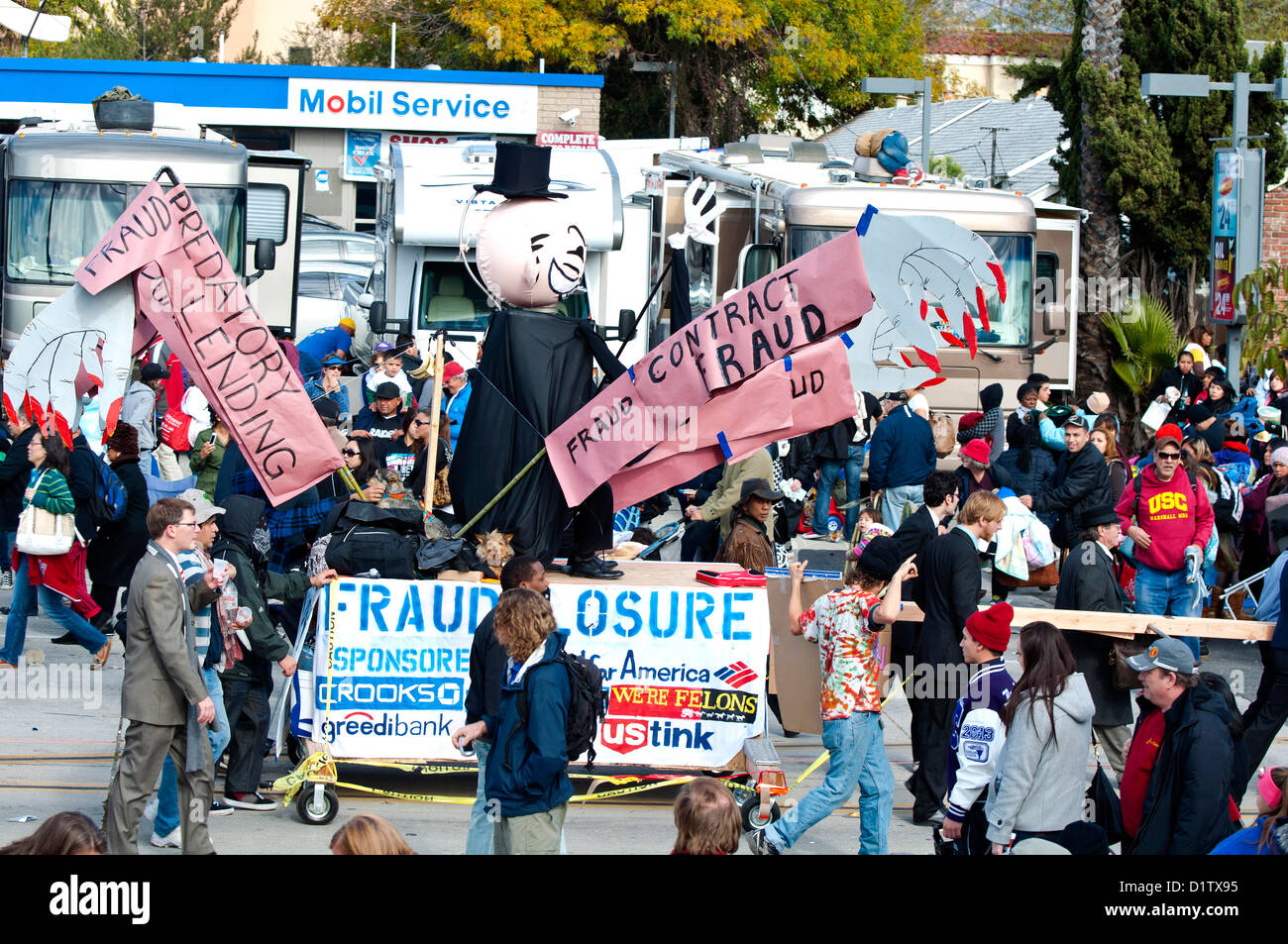 Protesters with the Occupy movement carry signs and characters to ...