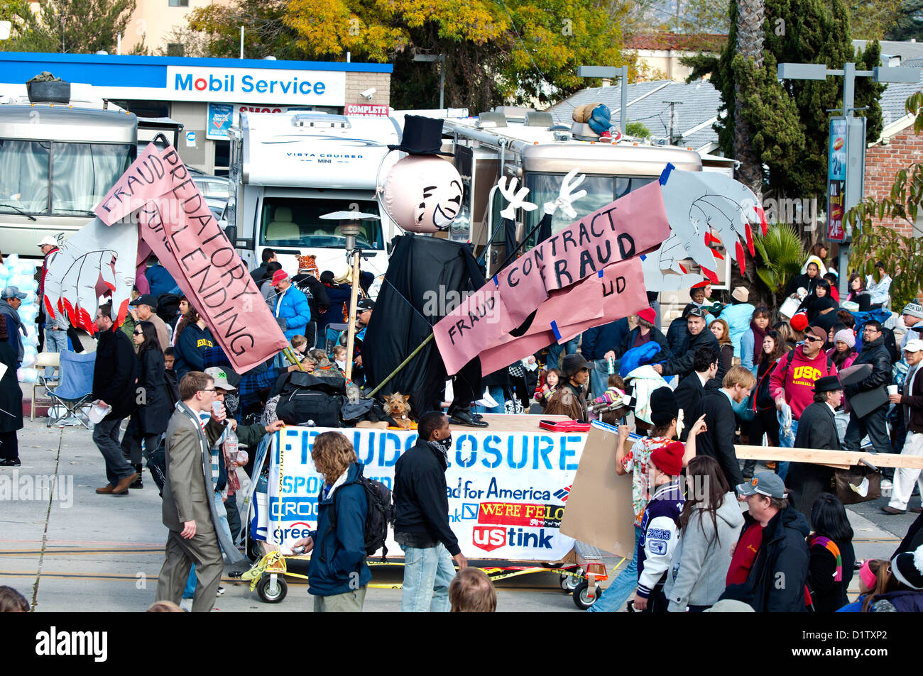 Protesters with the Occupy movement carry signs and characters to ...
