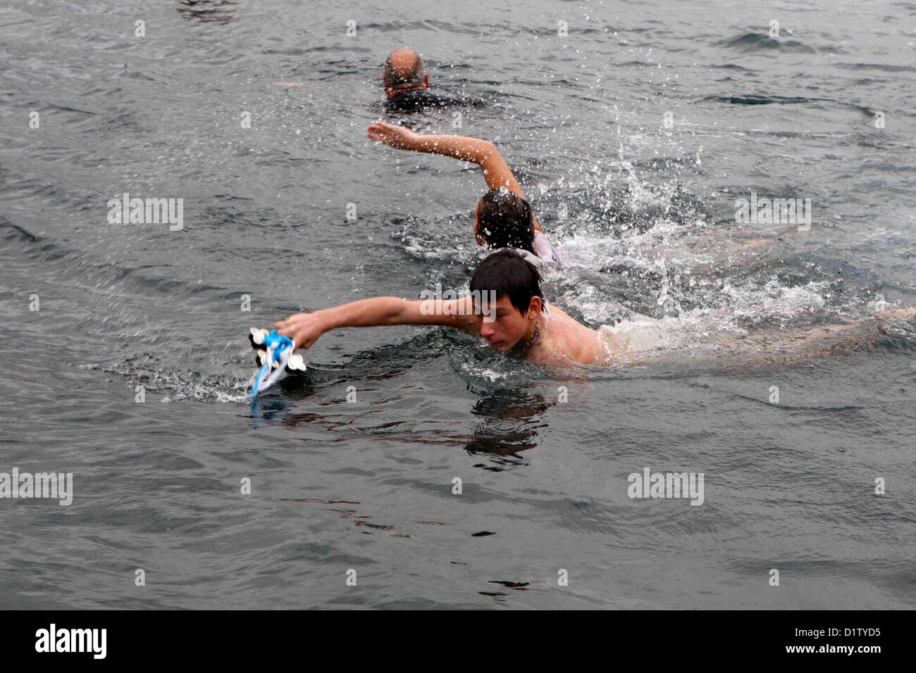 Jan. 6, 2013 - Perama, Greece - Young believers dip in the cold water ...