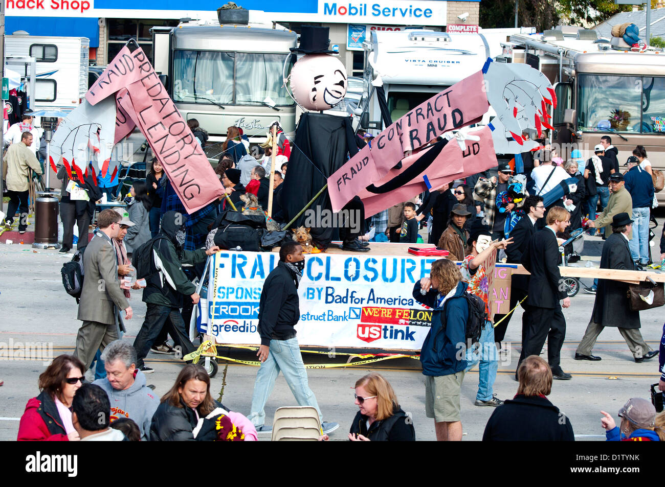 Protesters with the Occupy movement carry signs and characters to ...