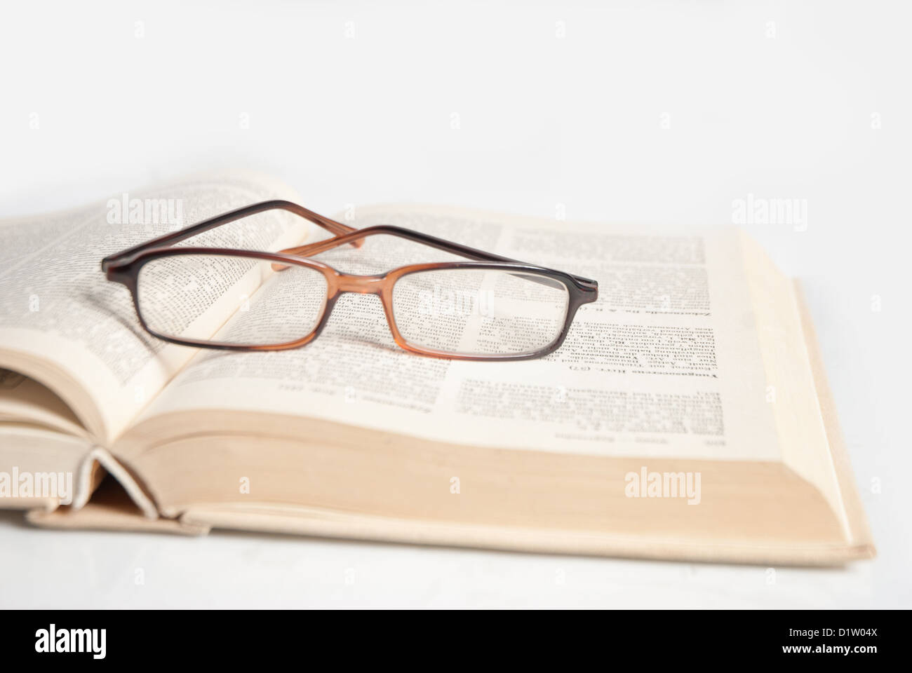 book with glasses isolated on white Stock Photo - Alamy