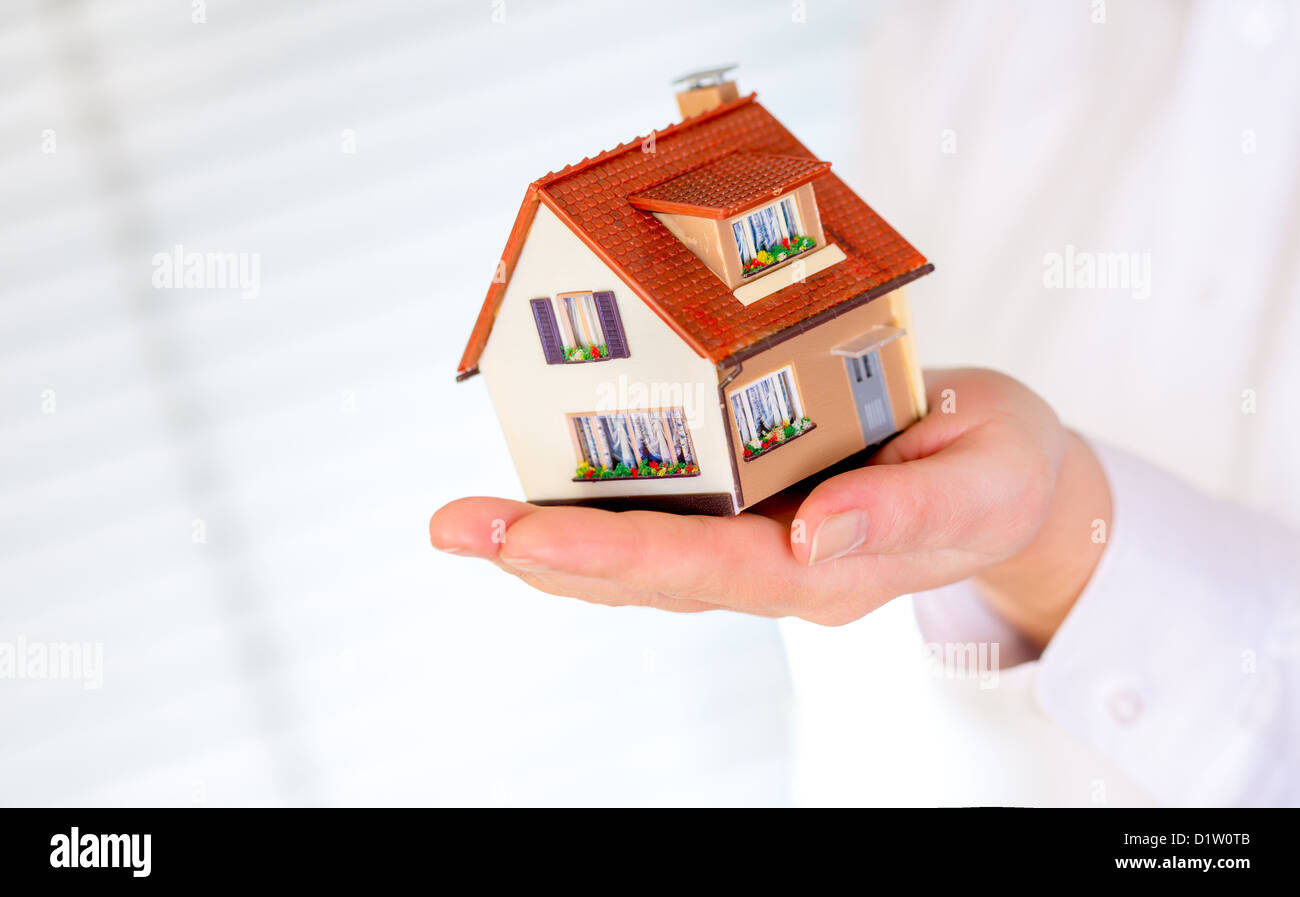 house in human hands on a white background Stock Photo - Alamy