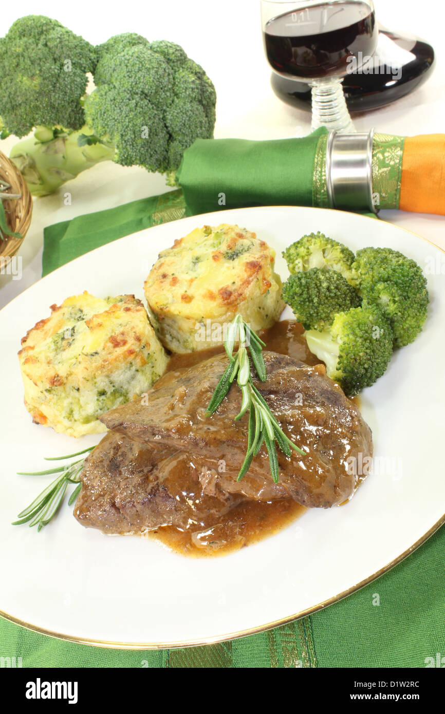 freshly cooked Venison medallions with gratin potatoes, broccoli and ...