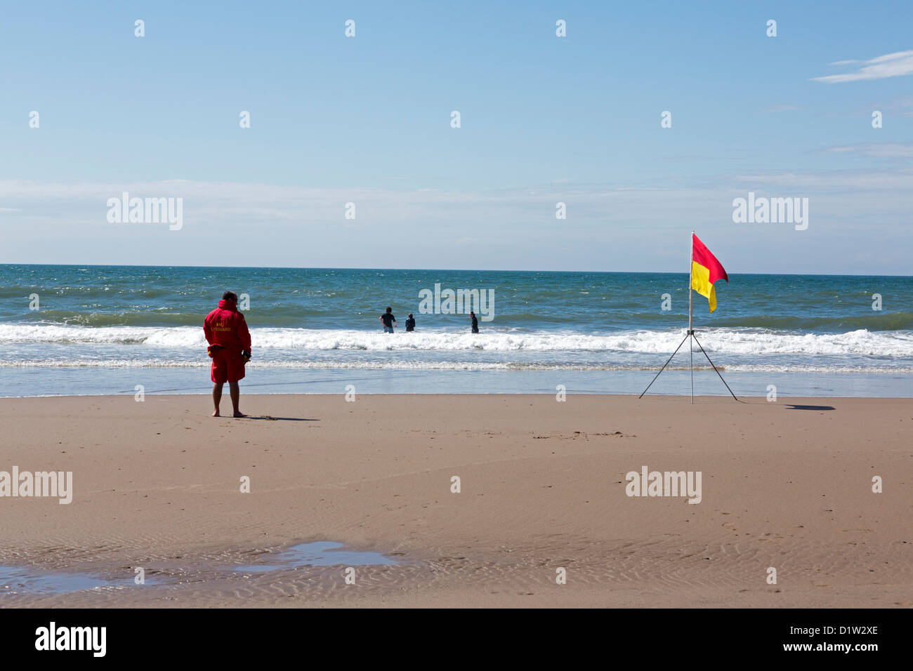 Llangrannog holiday 2012 lifeguard flag Stock Photo - Alamy