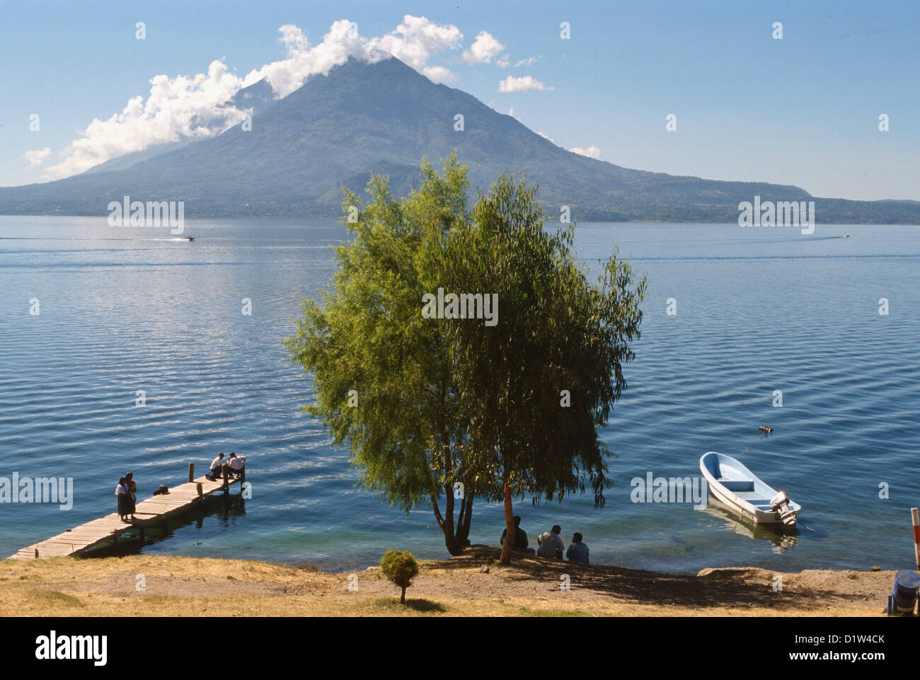 Volcanoes and boat on Lake Atitlan, Guatemala Stock Photo - Alamy