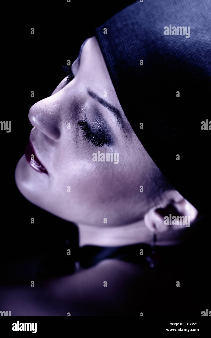 Side profile of a retro model in blue light Stock Photo - Alamy