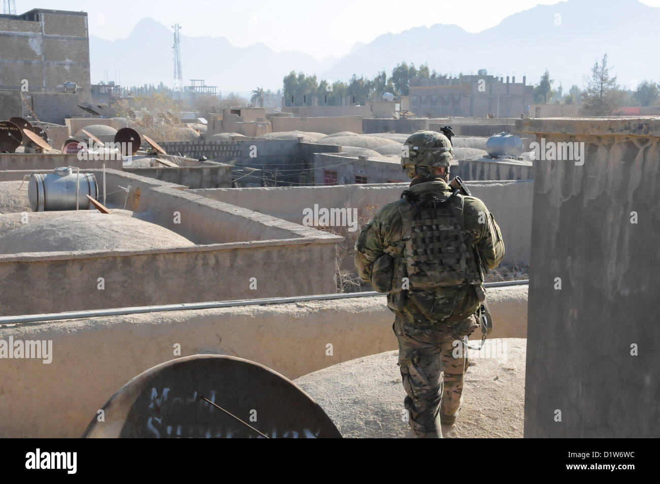 A U.S. Army soldier provides rooftop security during a key leader ...
