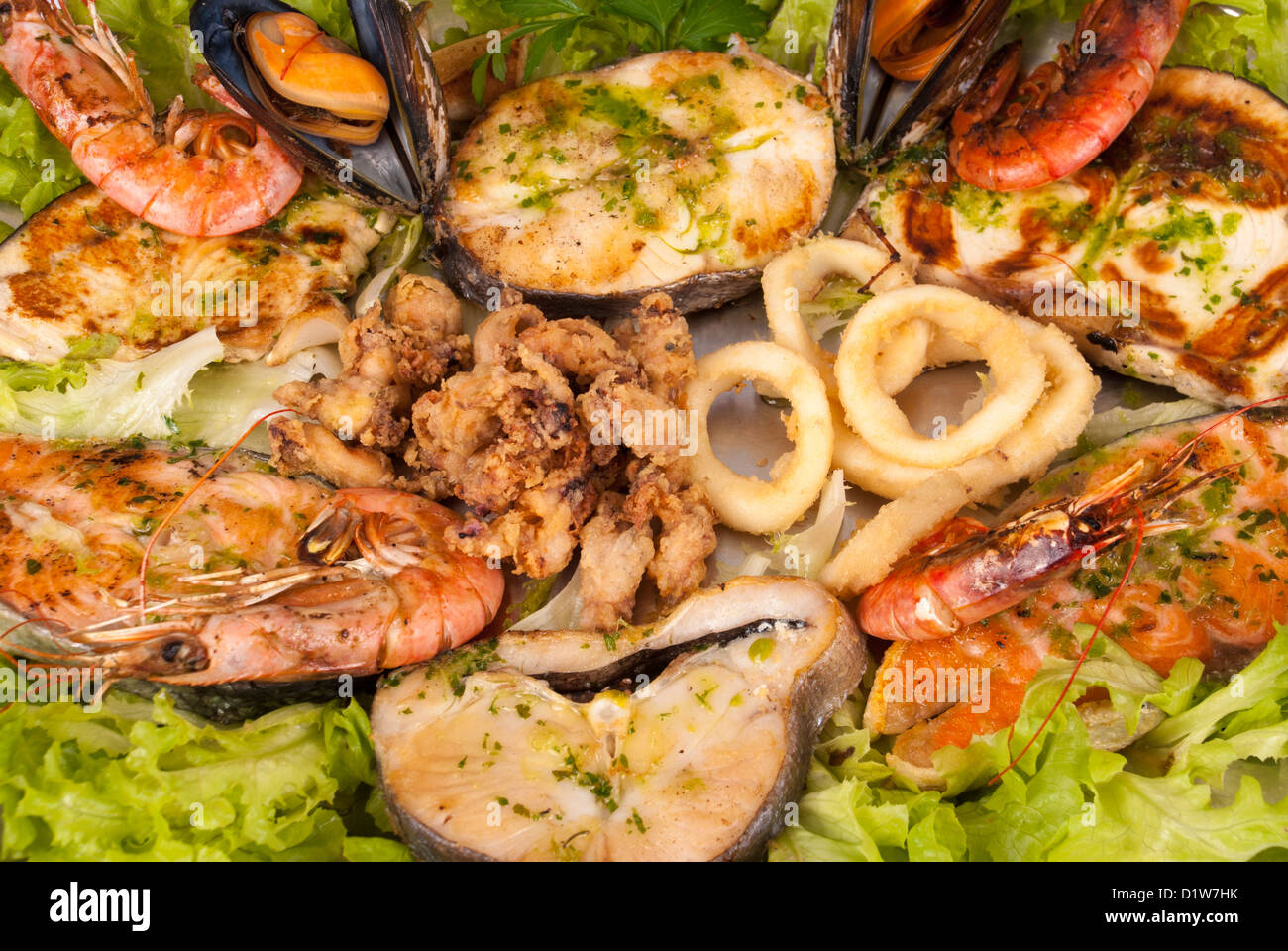 Assorted seafood grilled and served on salad Stock Photo - Alamy