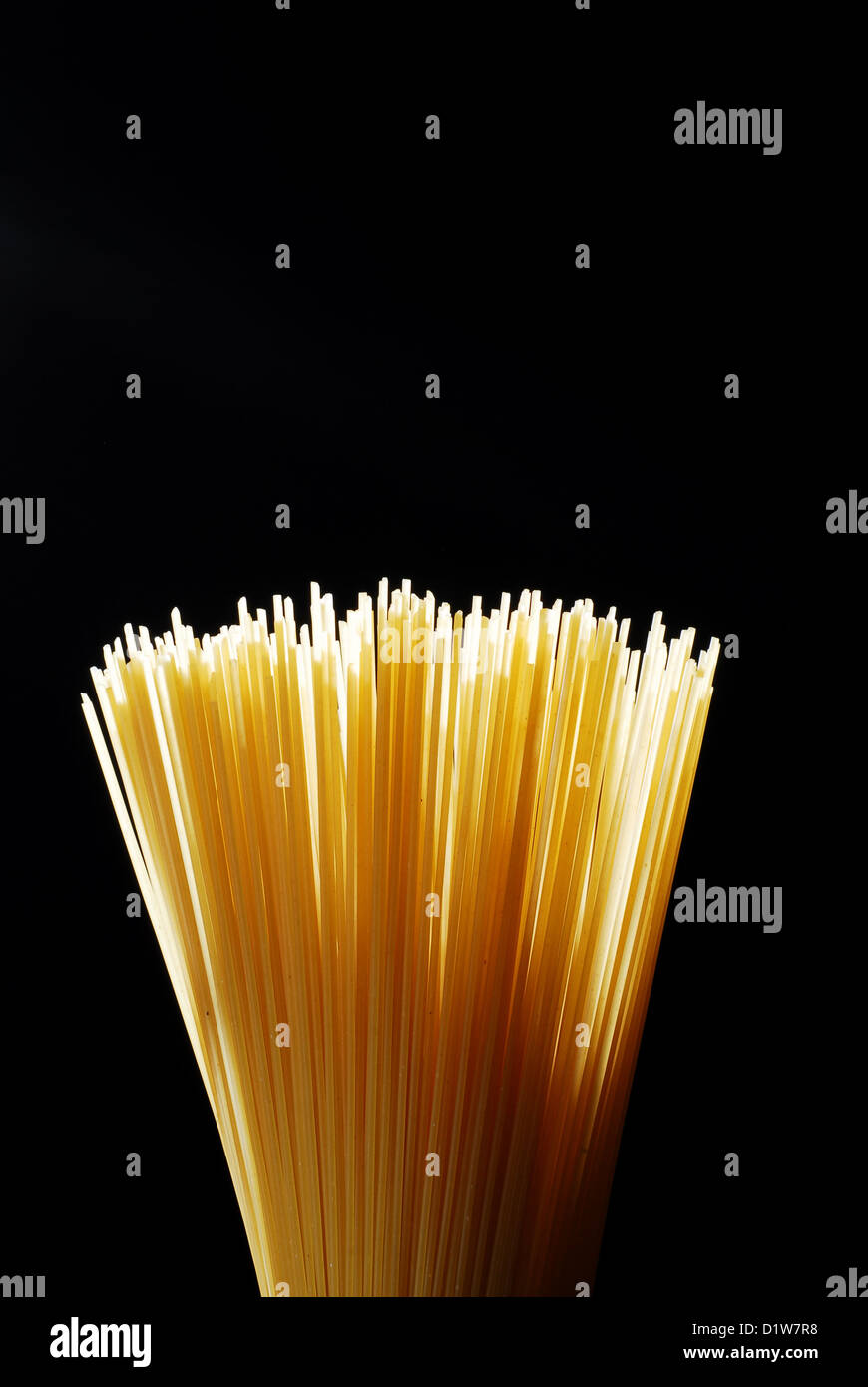 Yellow spaghetti tubes backlit isolated on black Stock Photo - Alamy