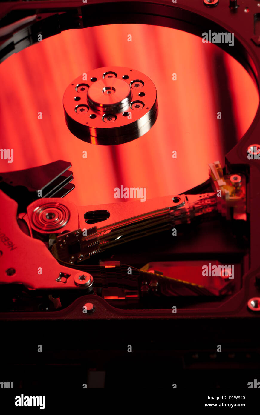 Reflective hard disk platter closeup with red light Stock Photo - Alamy