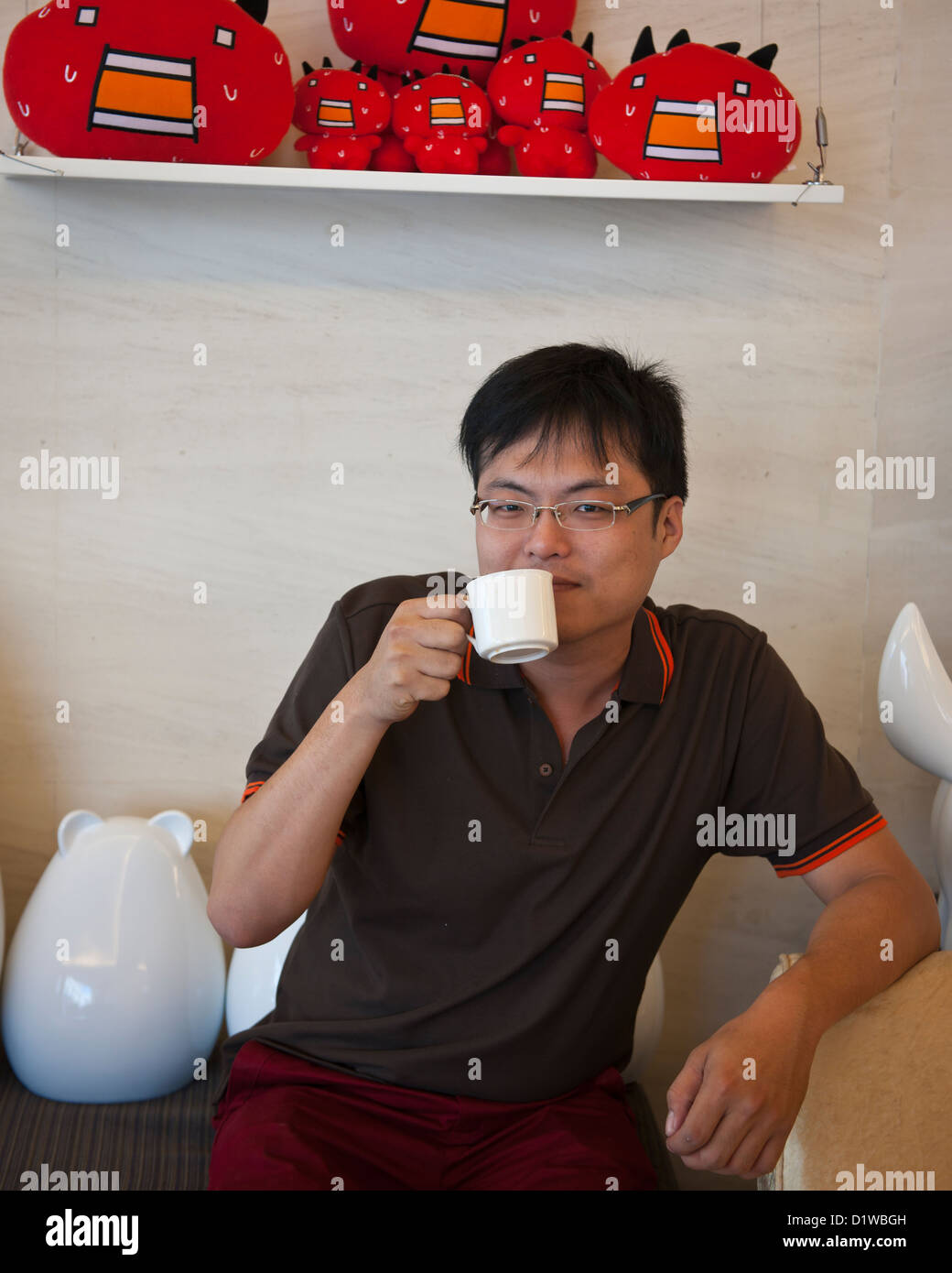 Chinese man drinking coffee Stock Photo - Alamy