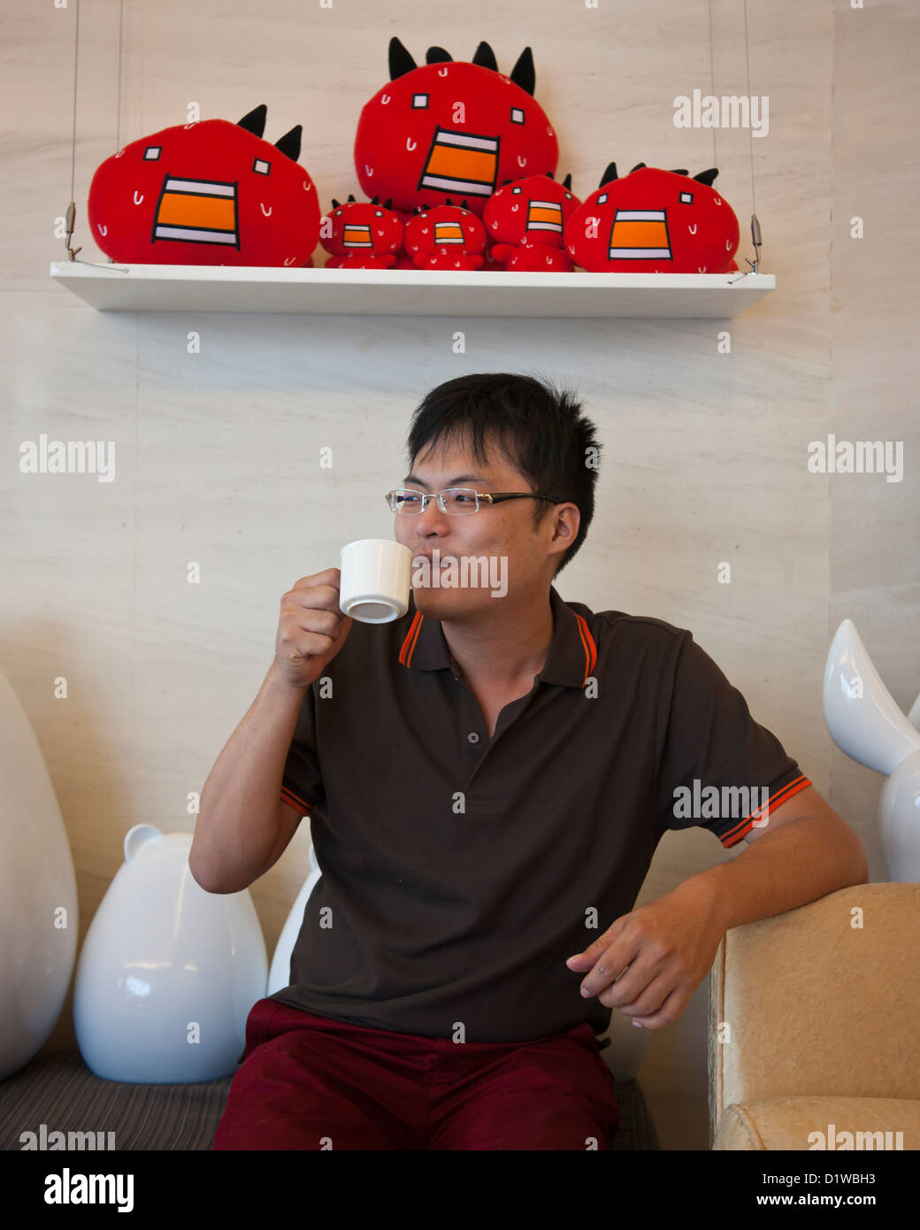Chinese man drinking coffee Stock Photo - Alamy