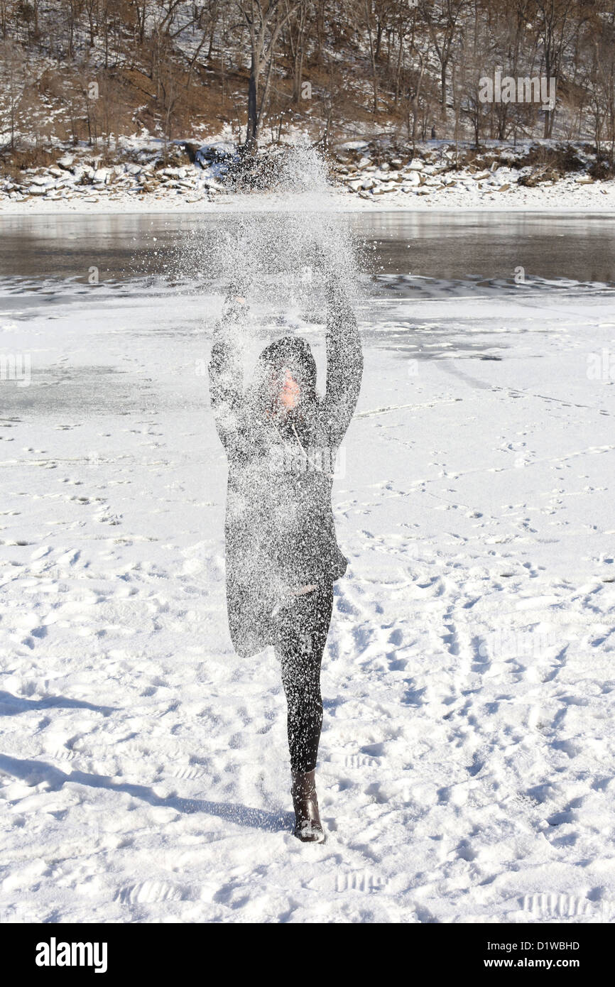 A person throwing snow in the air Stock Photo - Alamy