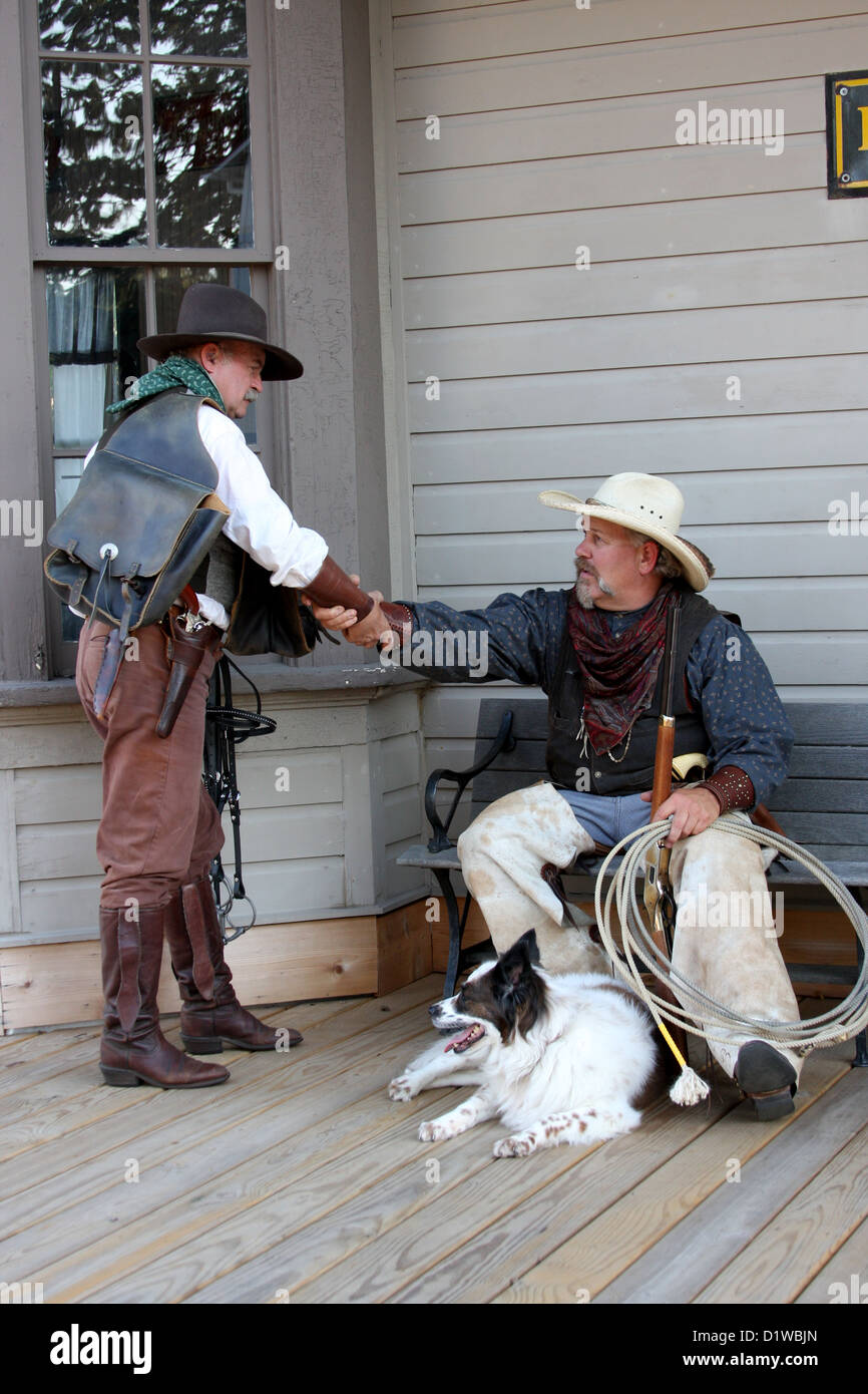 Two cowboys greeting with a handshake Stock Photo - Alamy