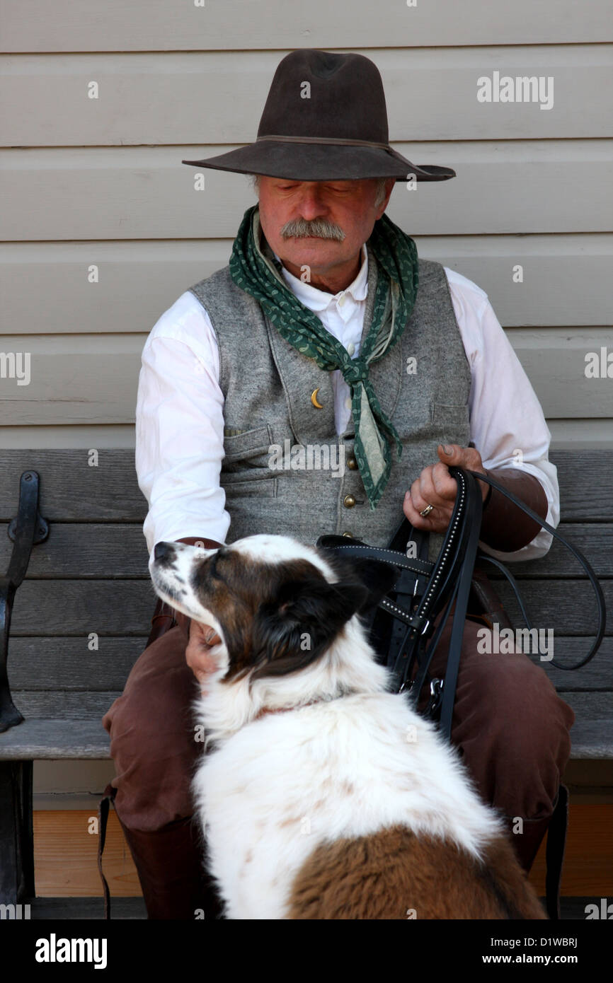 A cowboy petting his cowdog Border Collie Stock Photo - Alamy