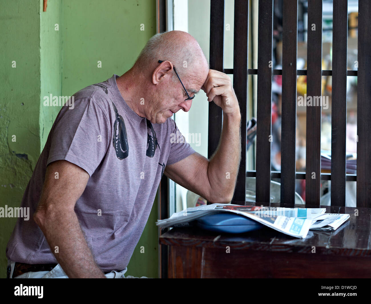 People newspaper thoughtful hi-res stock photography and images - Alamy