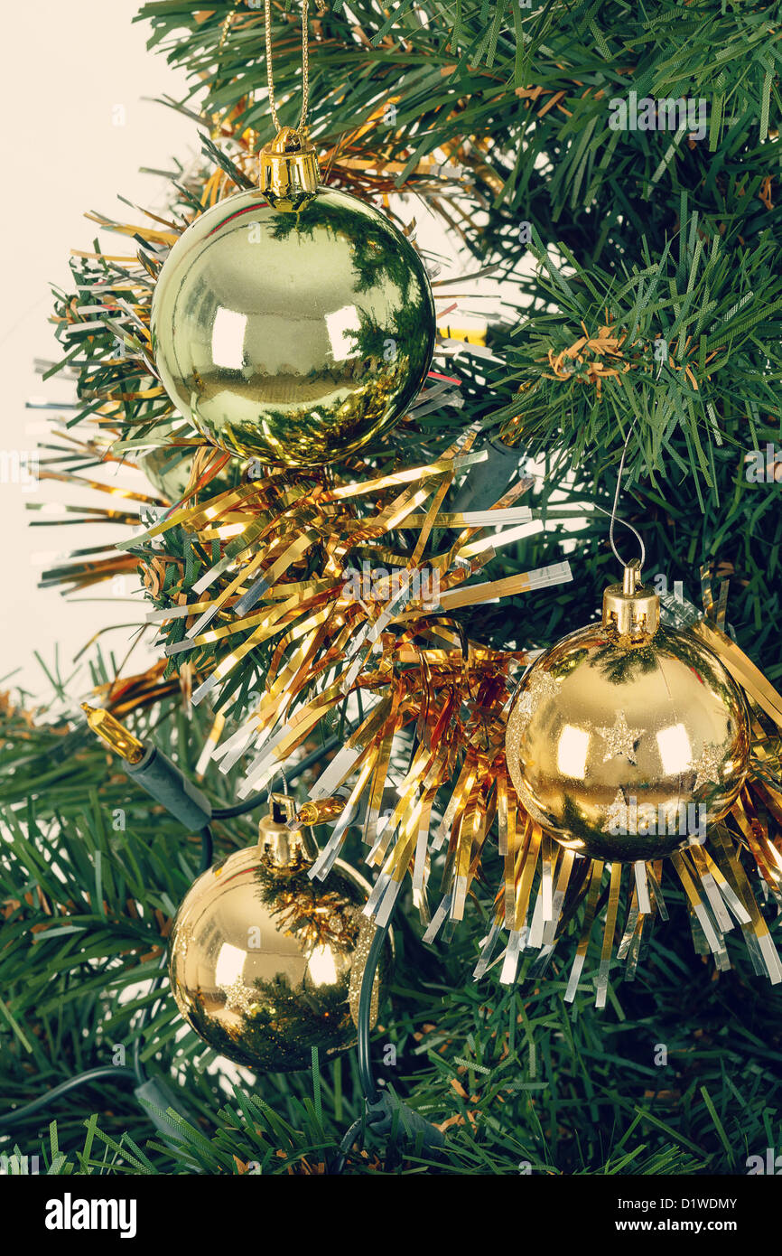 Decorated christmas tree with yellow and green balls on white ...