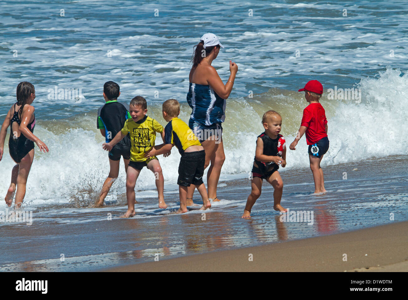 Children playing in waves hi-res stock photography and images - Alamy