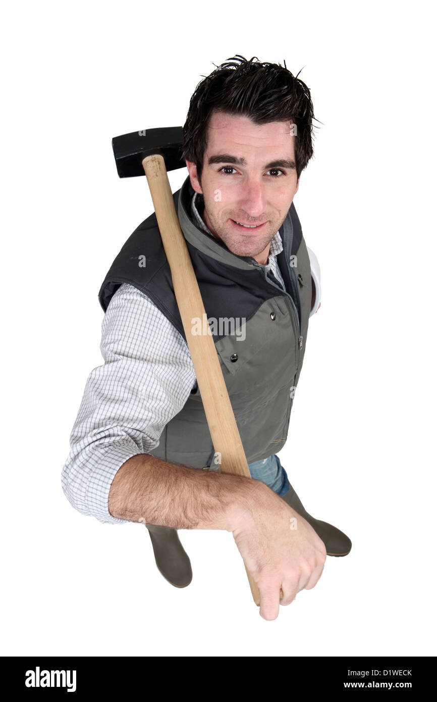 Man carrying sledge-hammer Stock Photo - Alamy