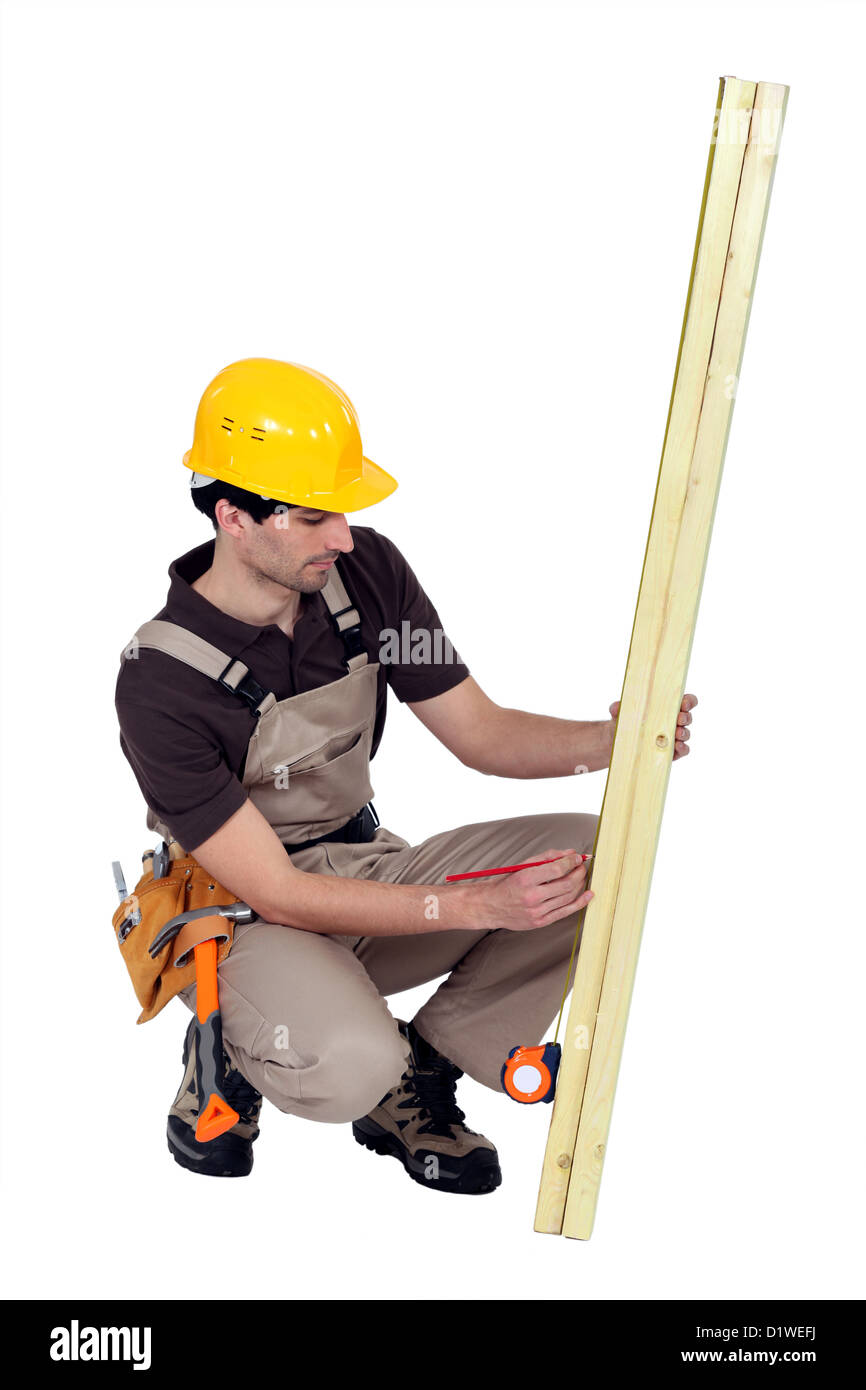 Man marking plank Stock Photo - Alamy