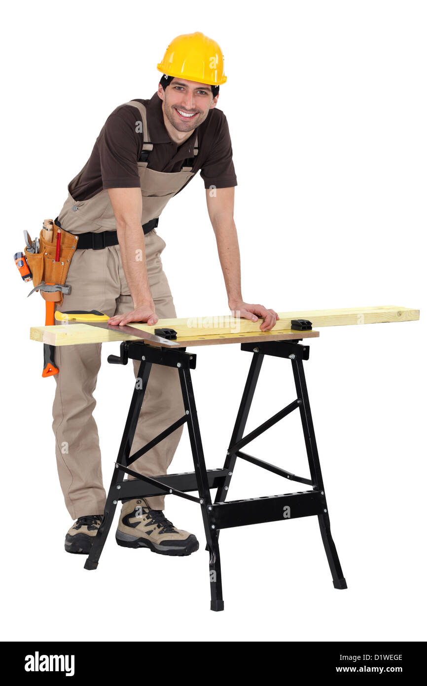 Man sawing wood on workbench Stock Photo - Alamy