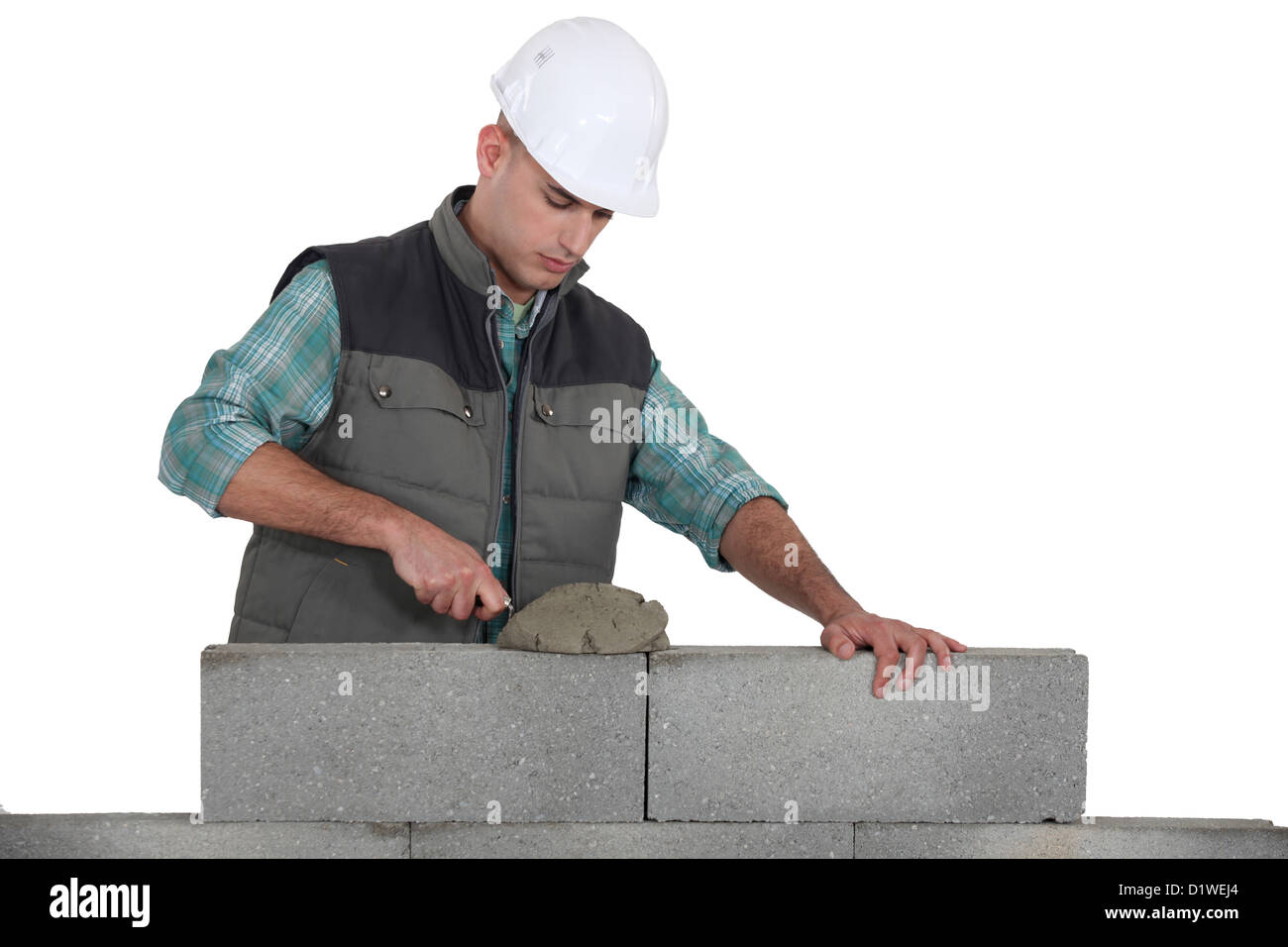 Bricklayer laying blocks Stock Photo - Alamy