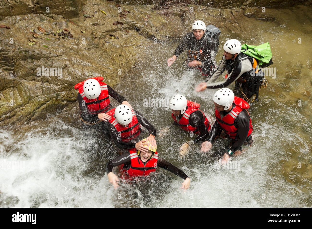 Group Of Adventurous People Fooling Around In A Nature Pool Stock Photo ...