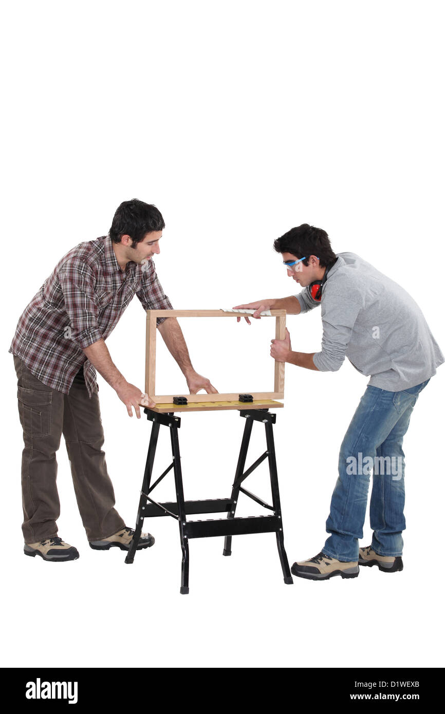 Carpenter and teenage helper Stock Photo - Alamy