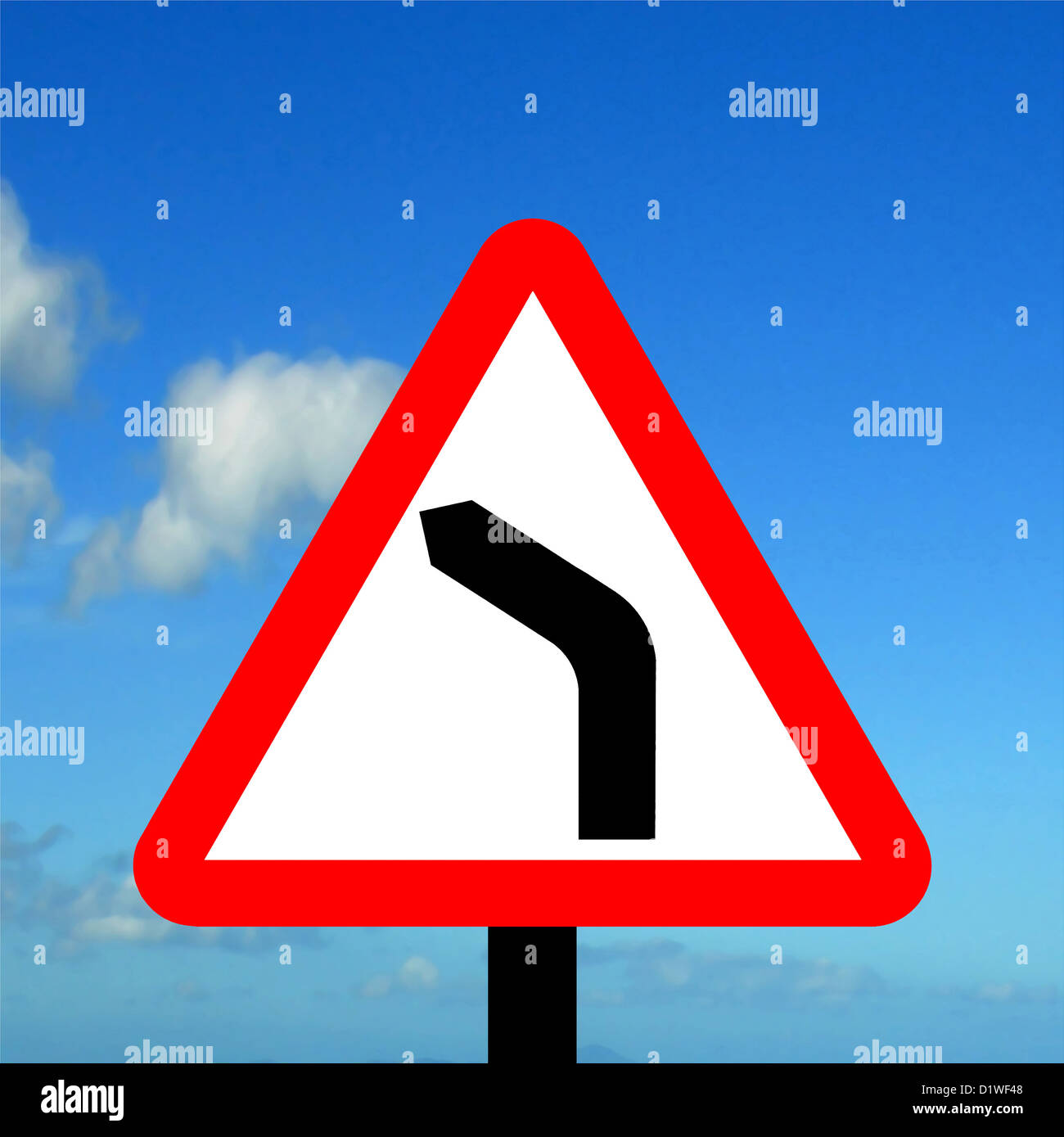 Warning triangle bend to left traffic sign Stock Photo - Alamy
