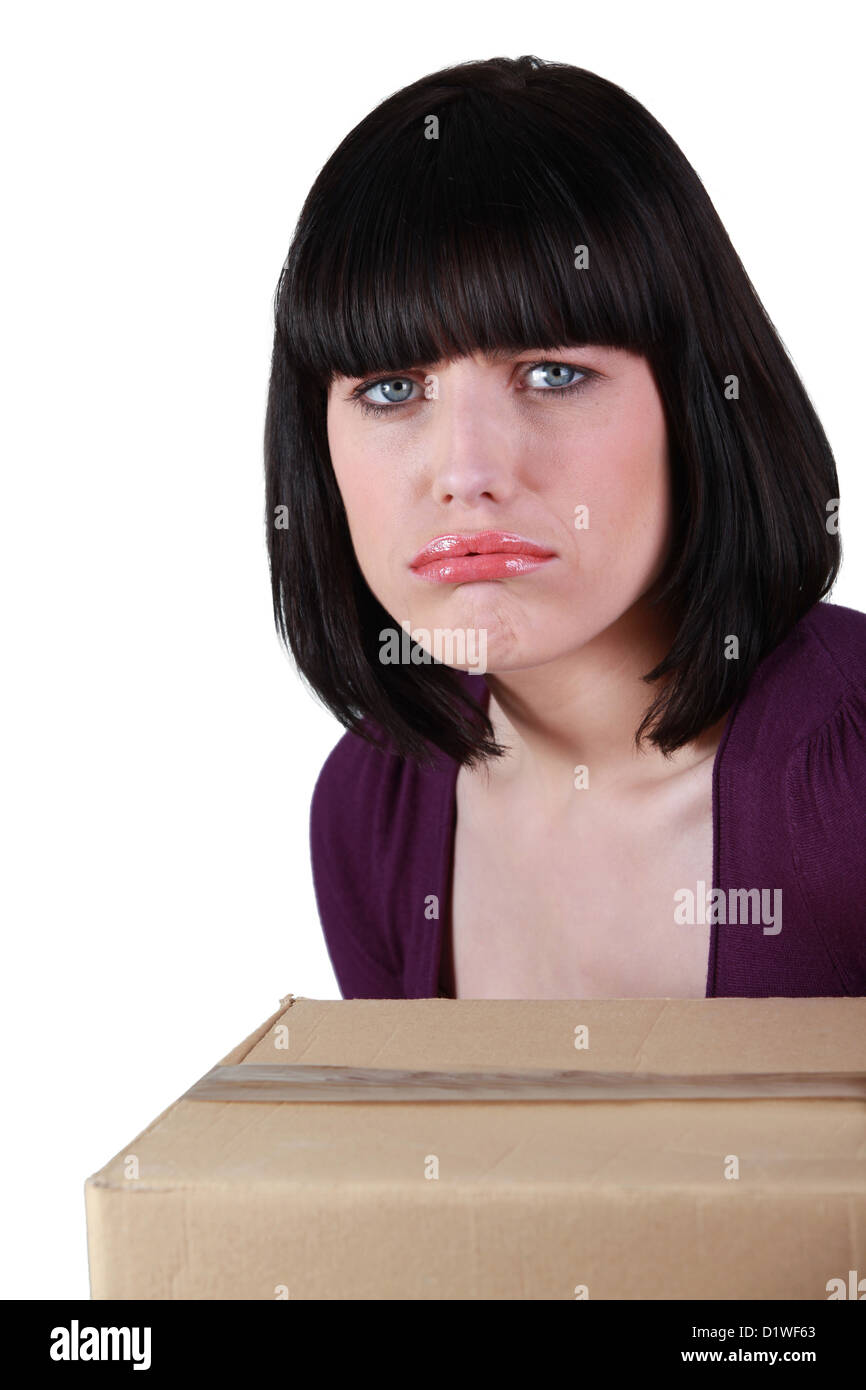 Sad brunette with box Stock Photo - Alamy