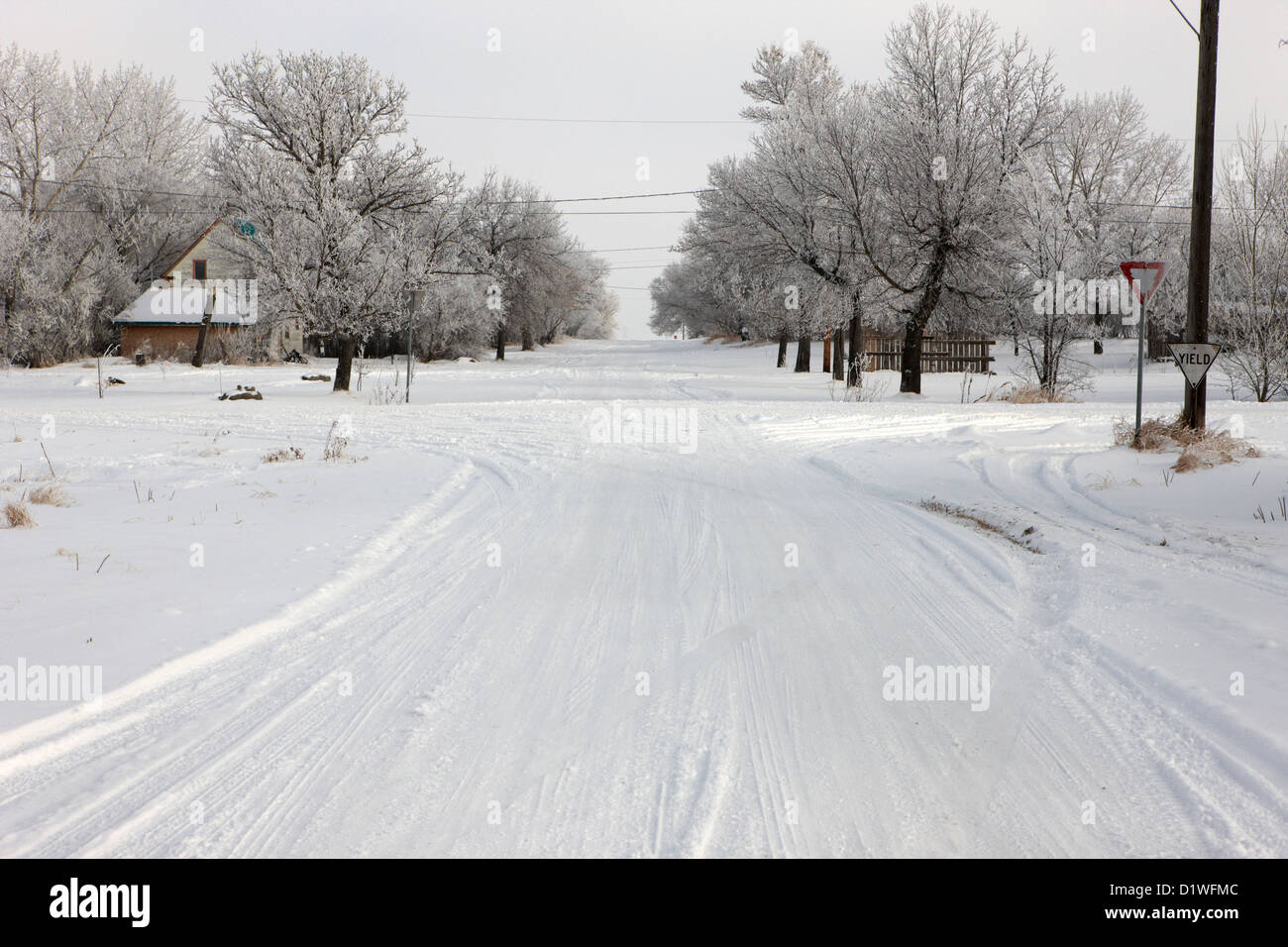 empty intersection on snow covered street in small rural farming ...