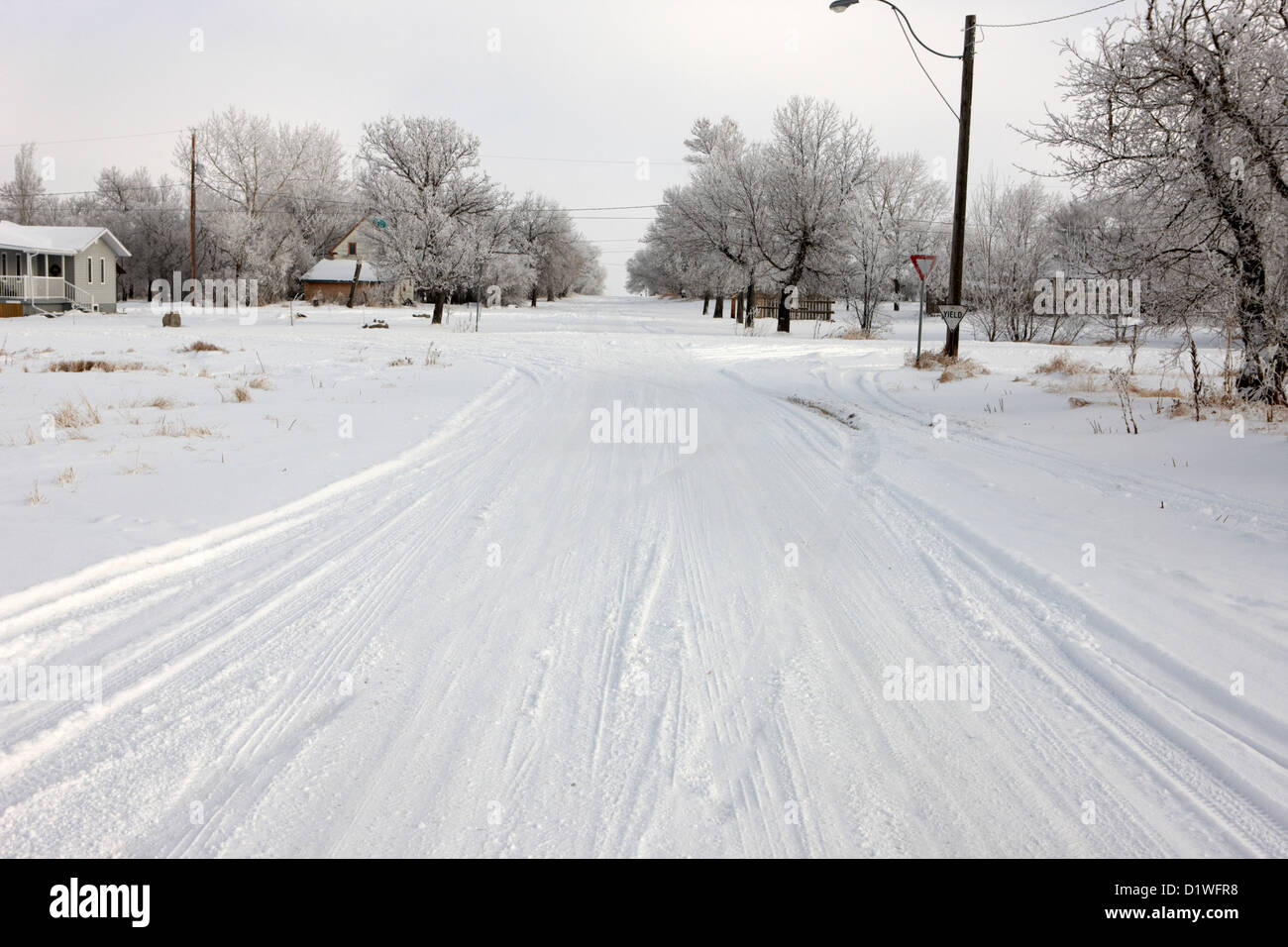 empty intersection on snow covered street in small rural farming ...