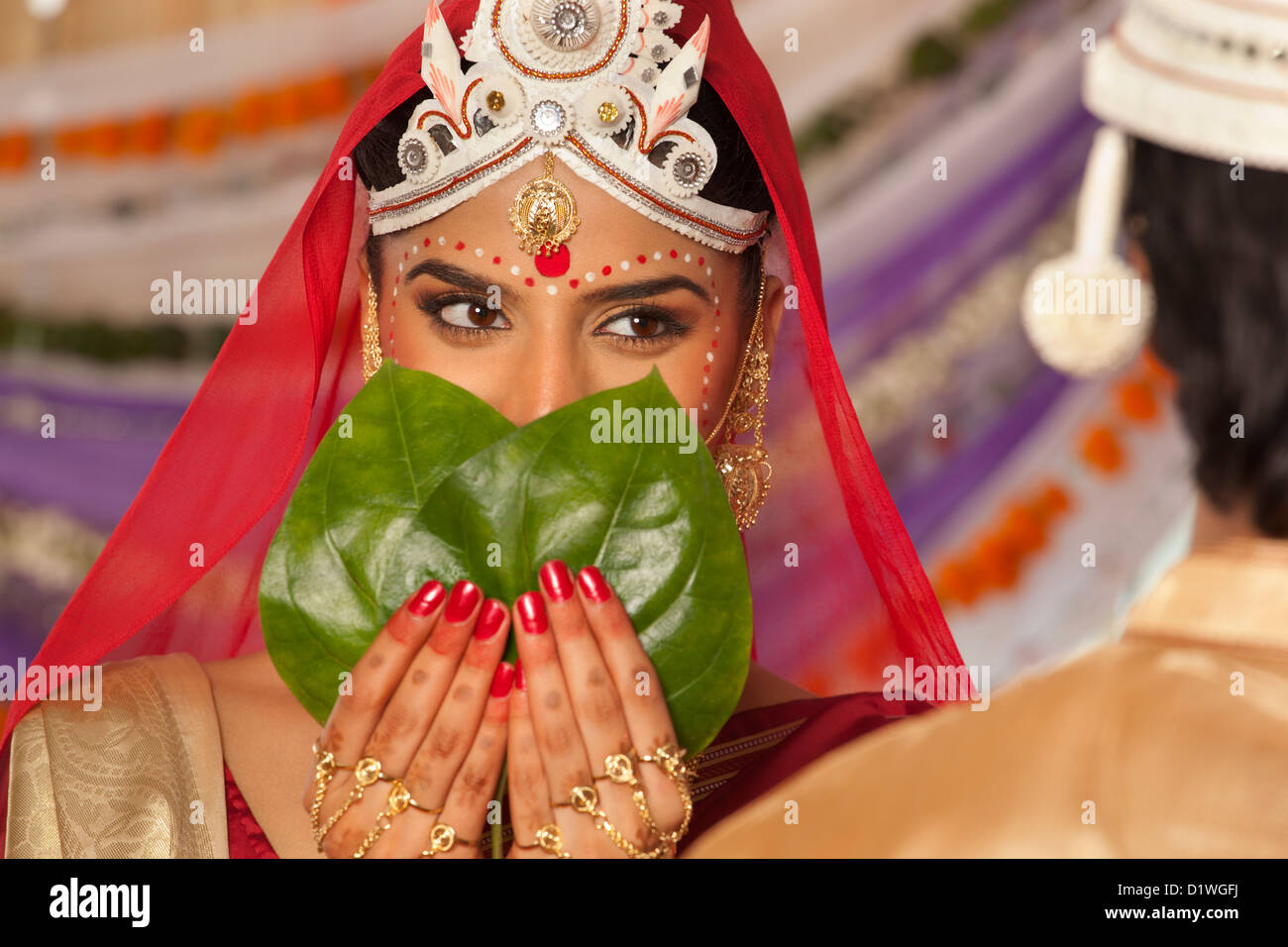 Bengali bride hiding her face from the groom Stock Photo - Alamy