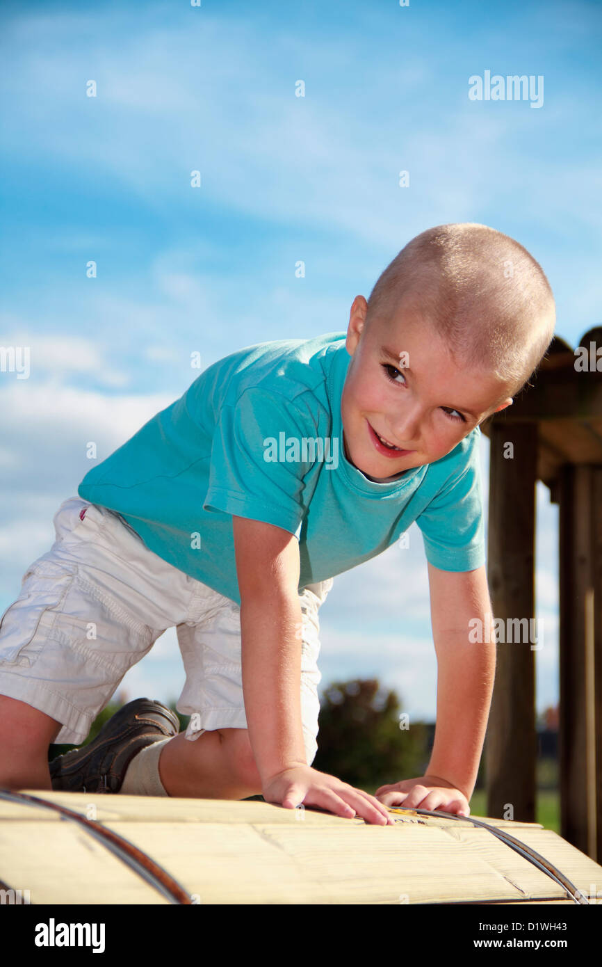 Boy (4-5) playing in playground Stock Photo - Alamy
