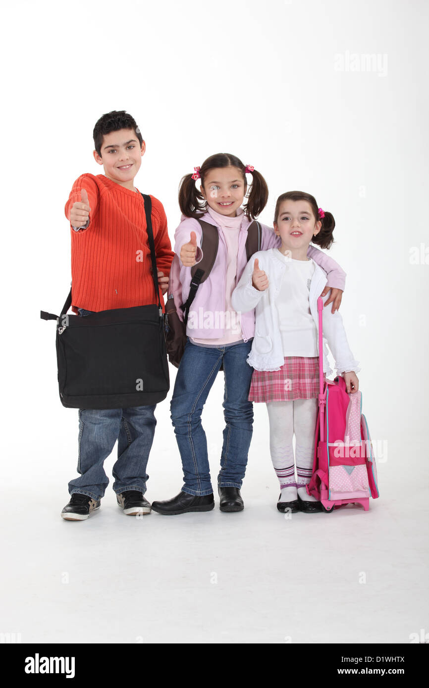 Three schoolkids with bags Stock Photo - Alamy