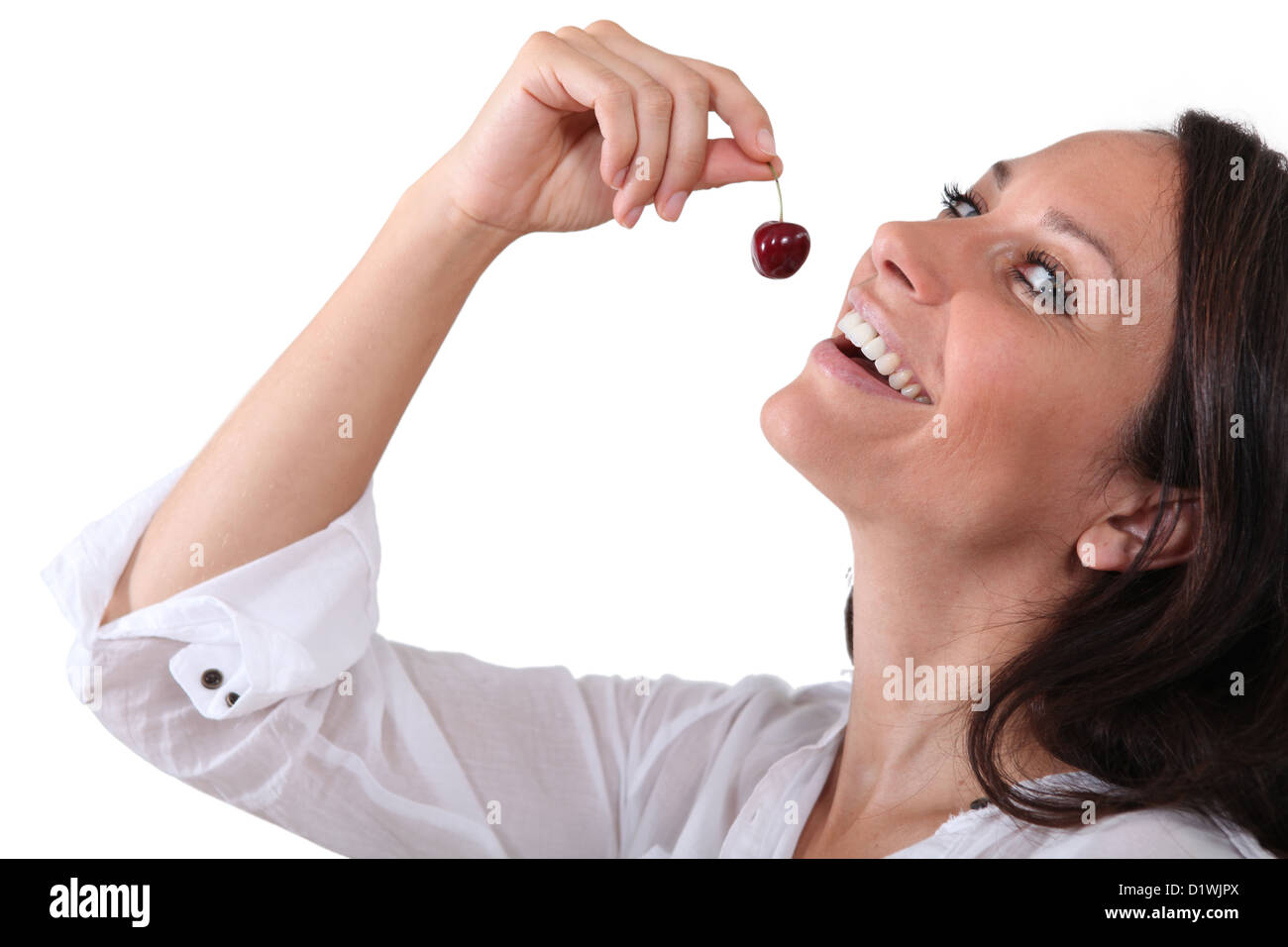 Woman eating a cherry Stock Photo - Alamy