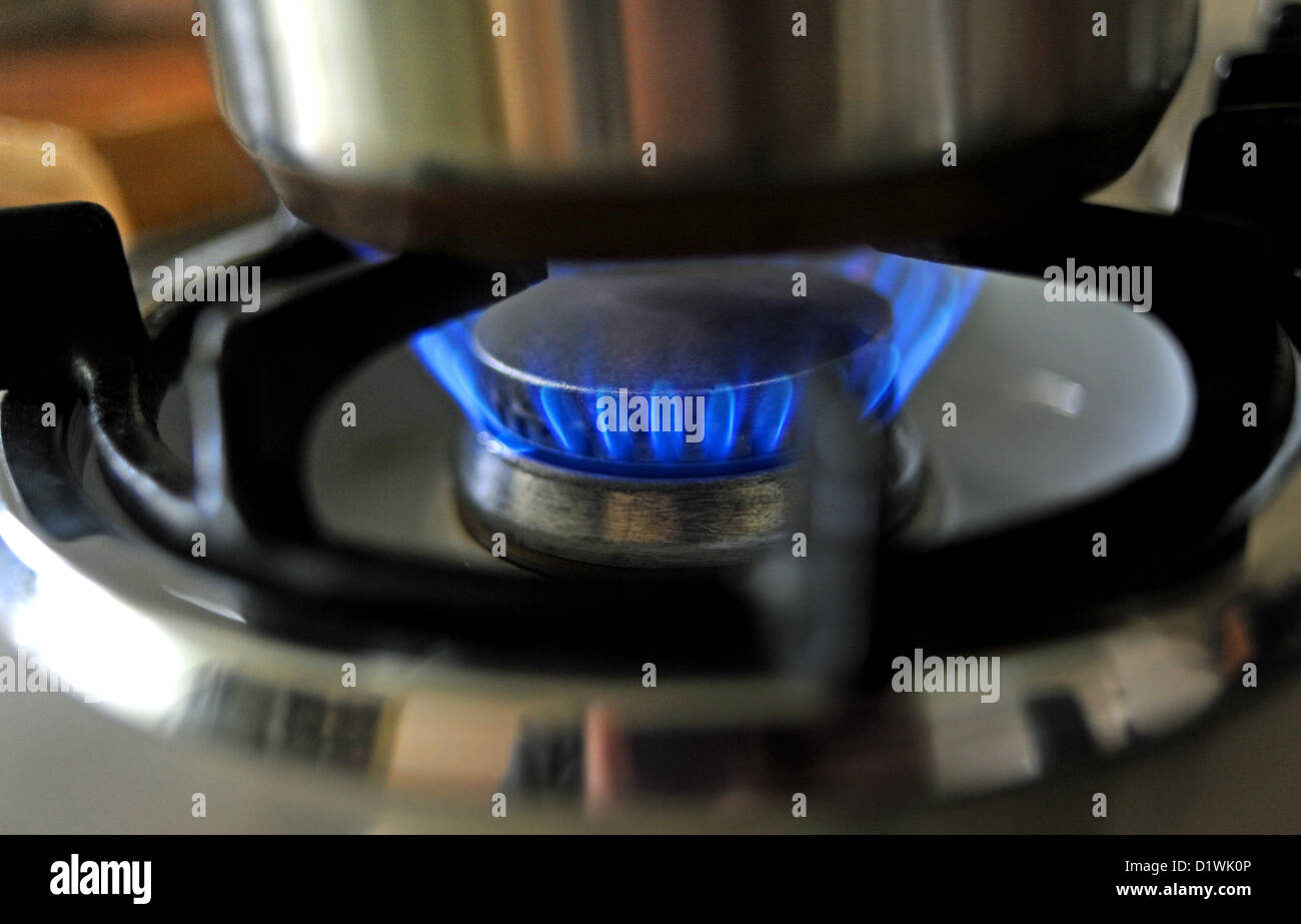 Gas flame alight under a saucepan on a cooking hob UK Stock Photo - Alamy