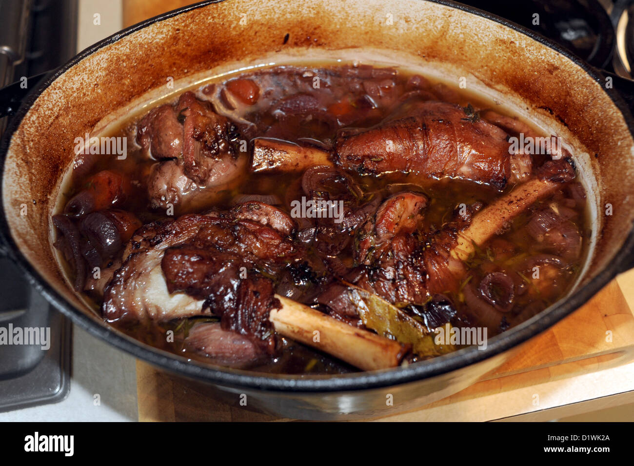 Hearty winter casserole dish of Lamb Shank legs cooked slowly in red ...
