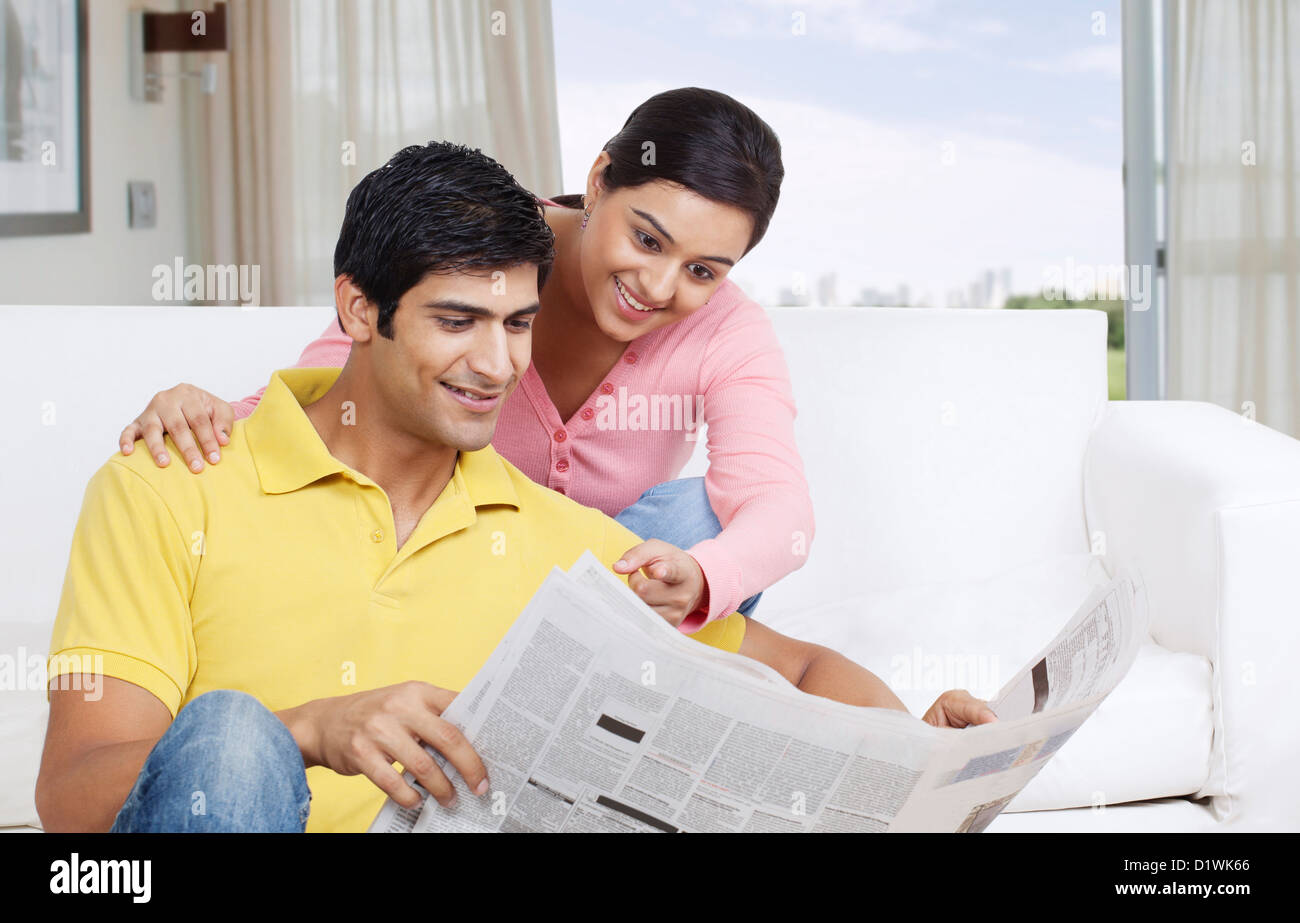 Couple reading the newspaper Stock Photo - Alamy