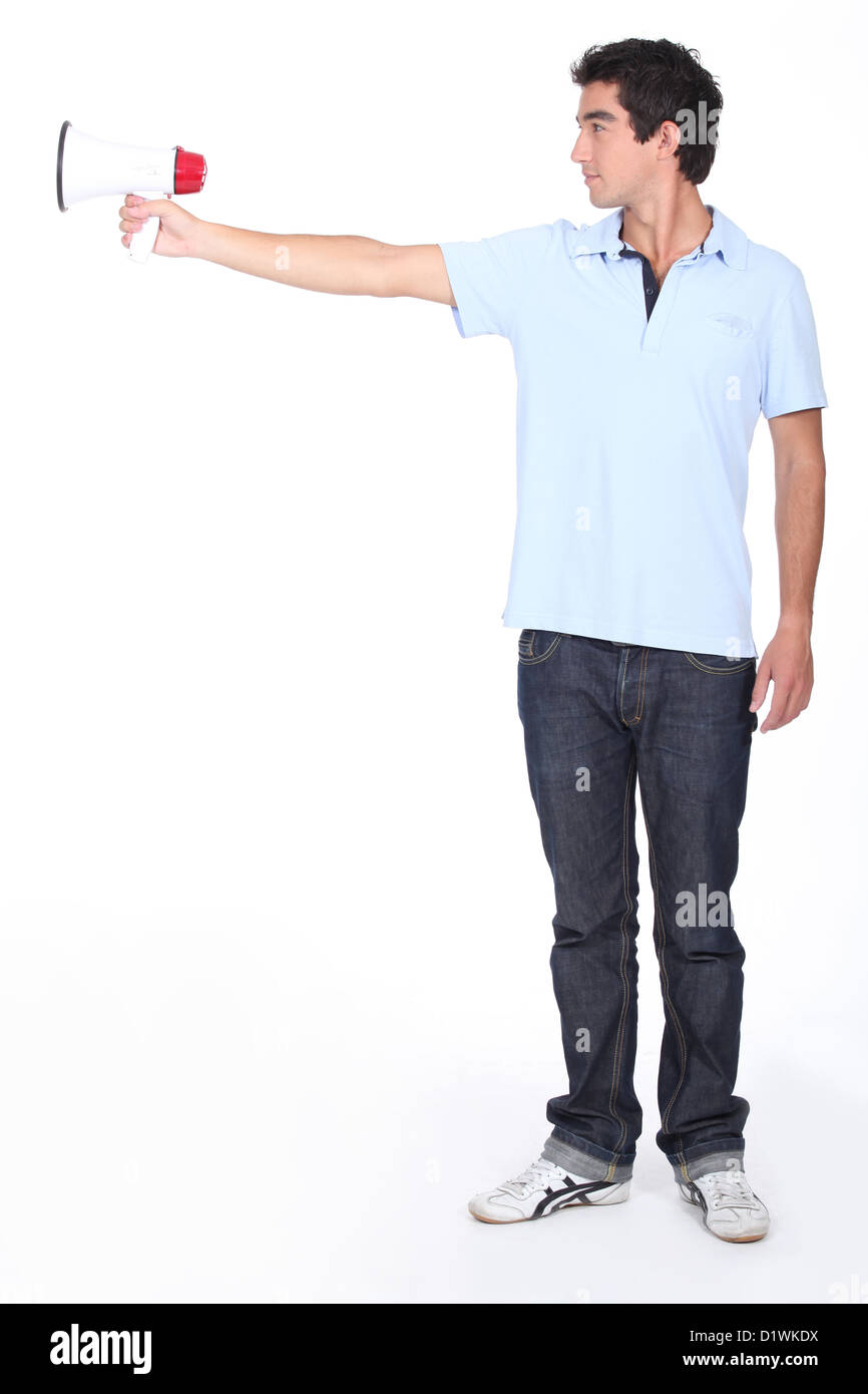 a teenage boy using a megaphone like a gun Stock Photo - Alamy