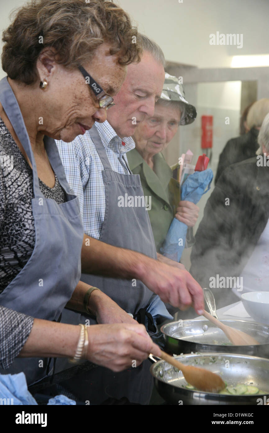 Pensioners learning cookery skills in cookery school Stock Photo - Alamy