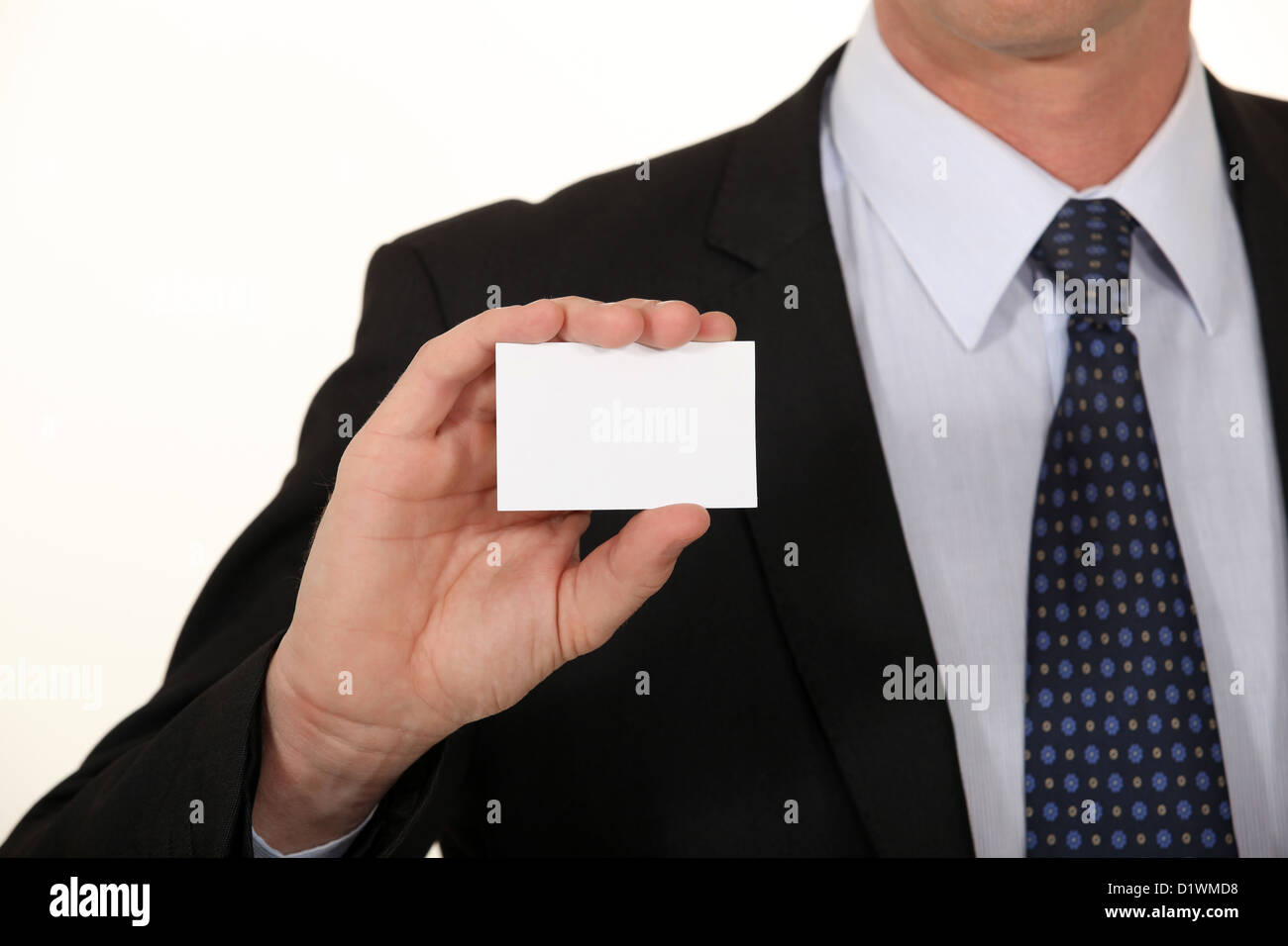 Businessman holding card Stock Photo - Alamy