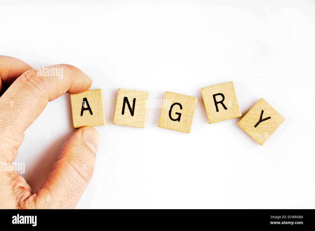male hand spelling word angry with scrabble tiles Stock Photo - Alamy