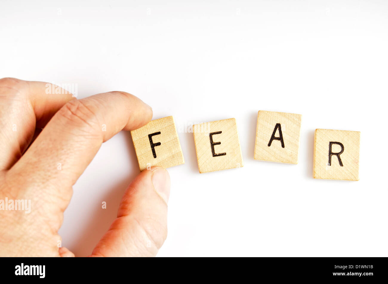 male hand spelling word fear with scrabble tiles Stock Photo - Alamy