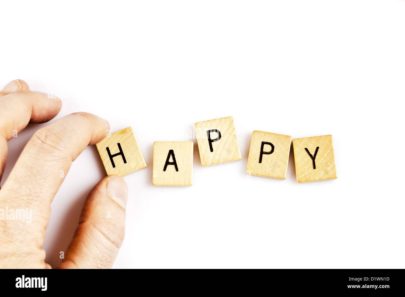 male hand spelling word happy with scrabble tiles Stock Photo - Alamy