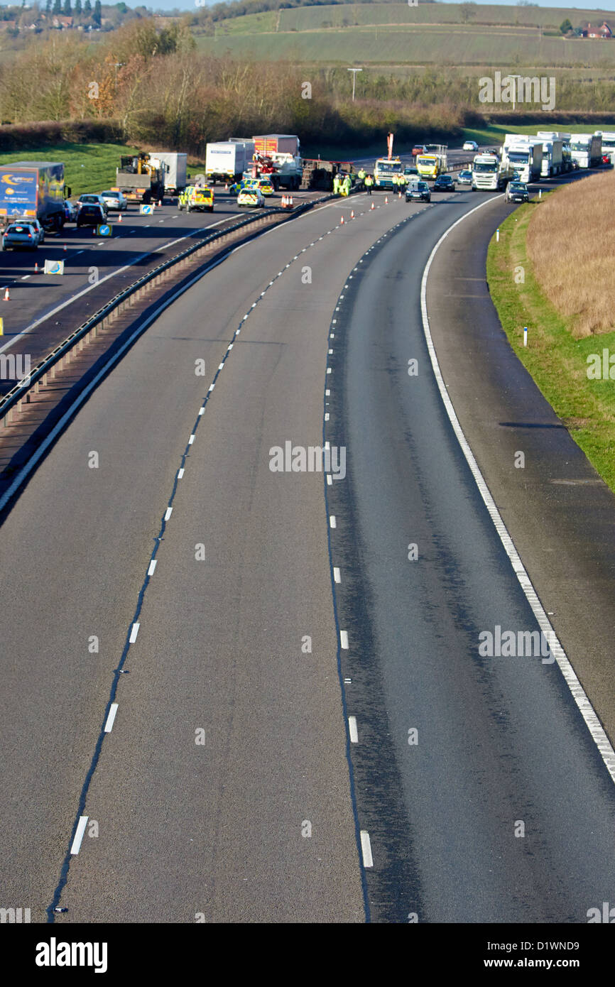 Police and highway agency workers recover an overturned car transporter ...