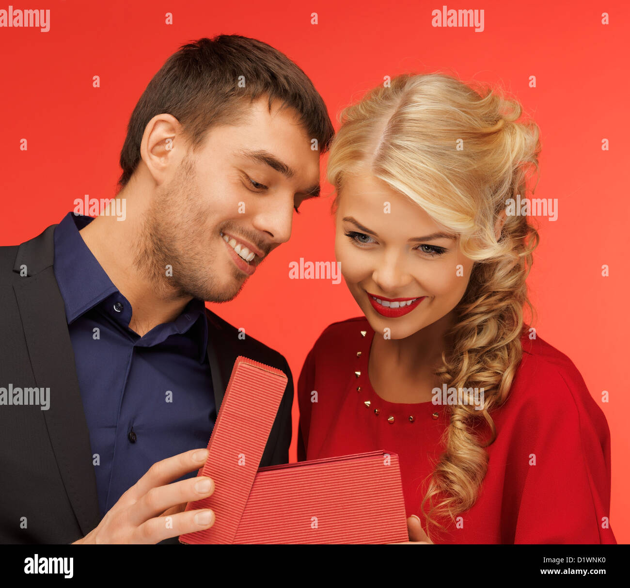 man and woman looking inside the gift box Stock Photo - Alamy
