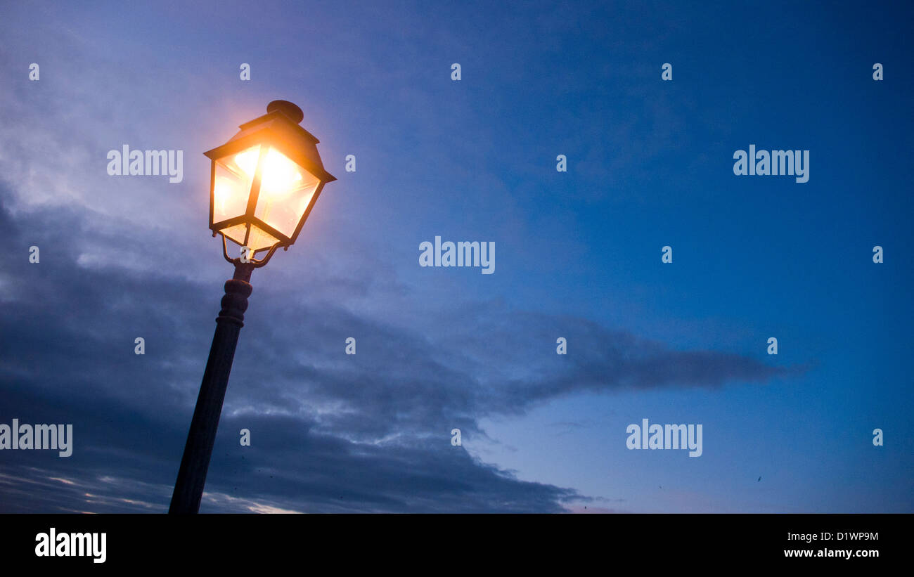 Illuminated streetlamp,evening, blue sky Stock Photo - Alamy